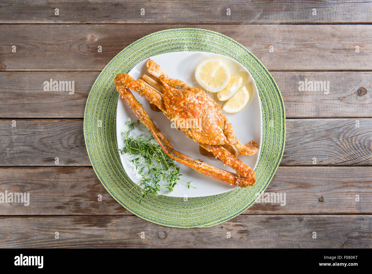 Top view cooked delicious hot and spicy sauce blue crab on white plate ...