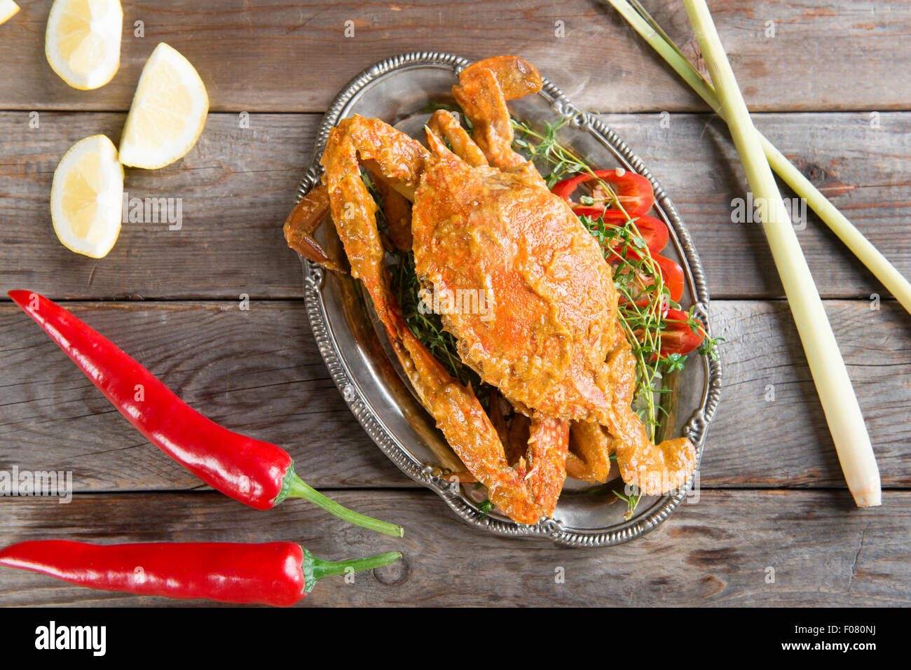 Top view cooked delicious hot and spicy sauce blue crab and ingredients ...