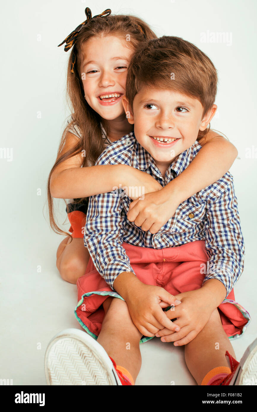 little cute boy and girl hugging playing on white background Stock Photo - Alamy