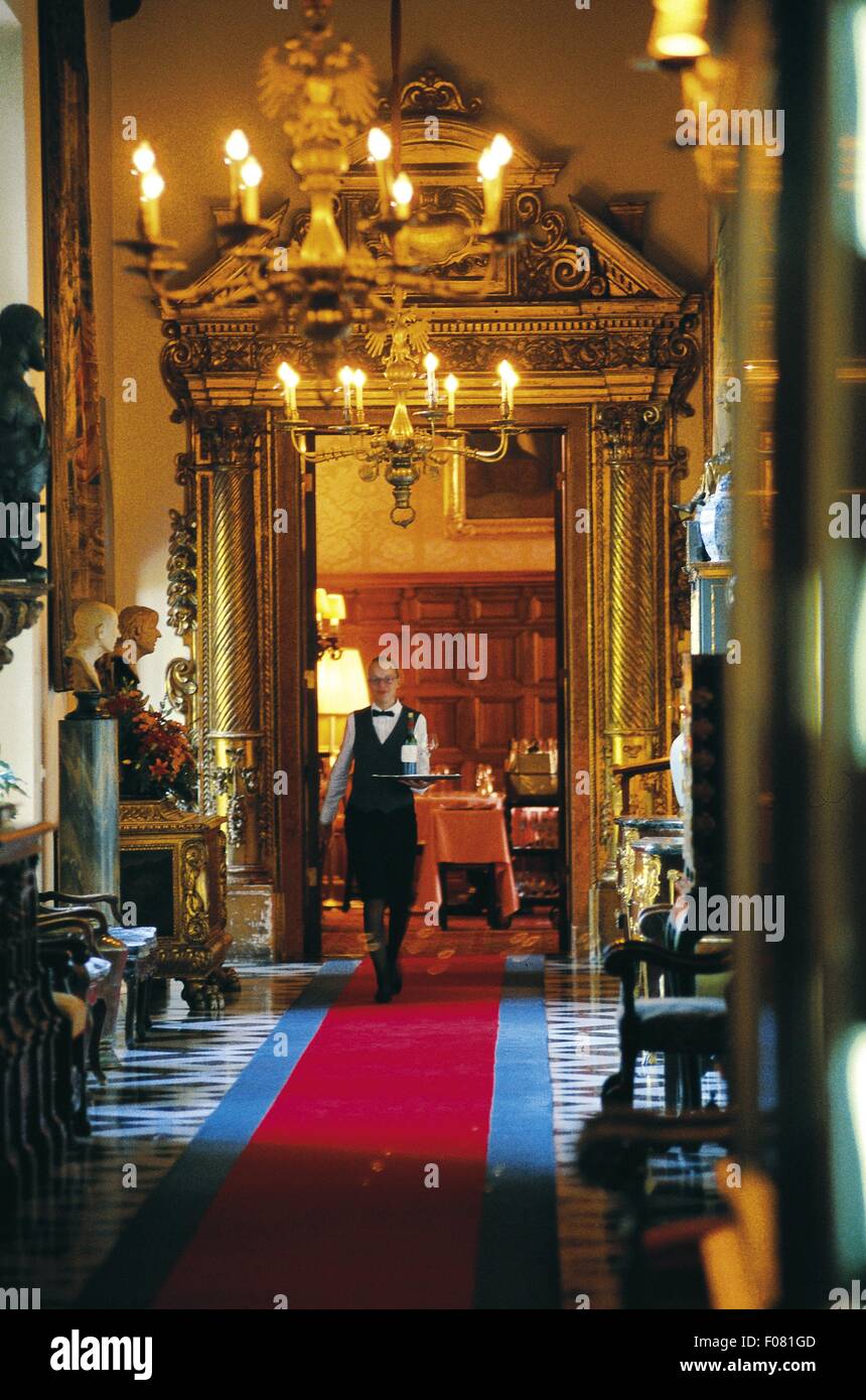 Waiter walking with tray in hand at Schlosshotel Kronberg Restaurant in ...
