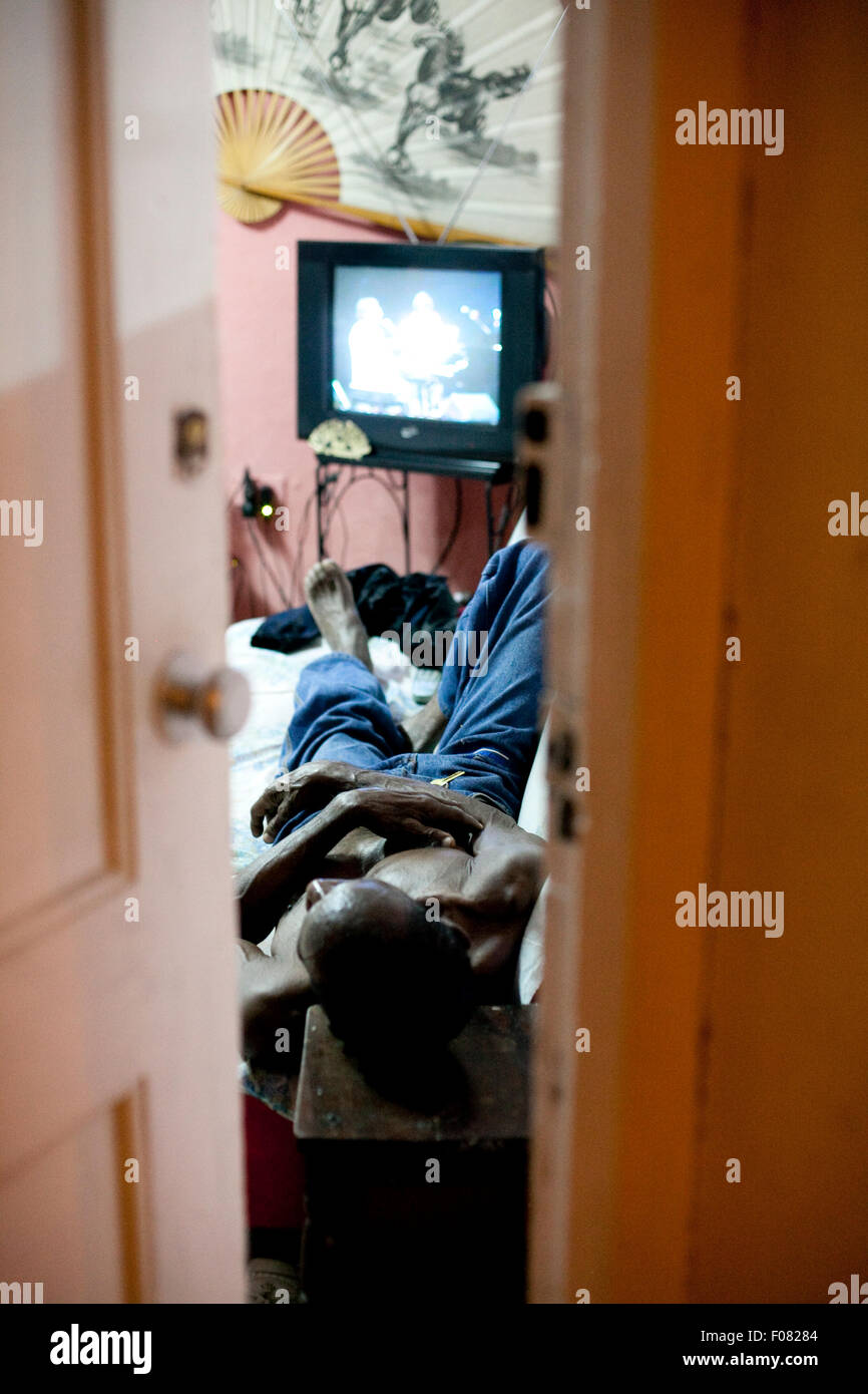 A man rests in his house while watching TV in Havana, Cuba Stock Photo ...
