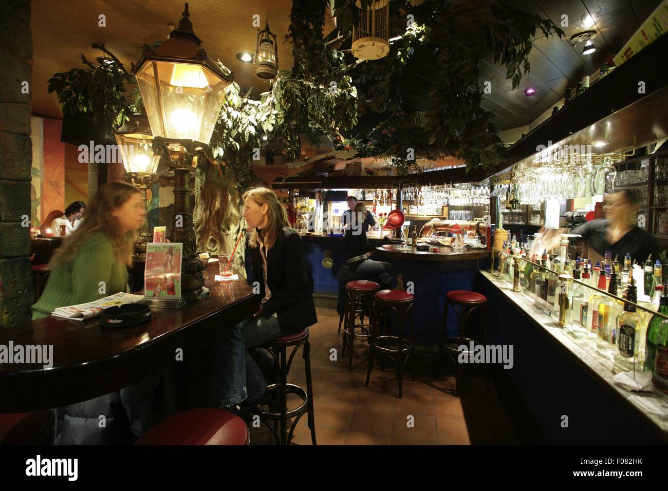 People sitting at bar counter in restaurant Stock Photo - Alamy