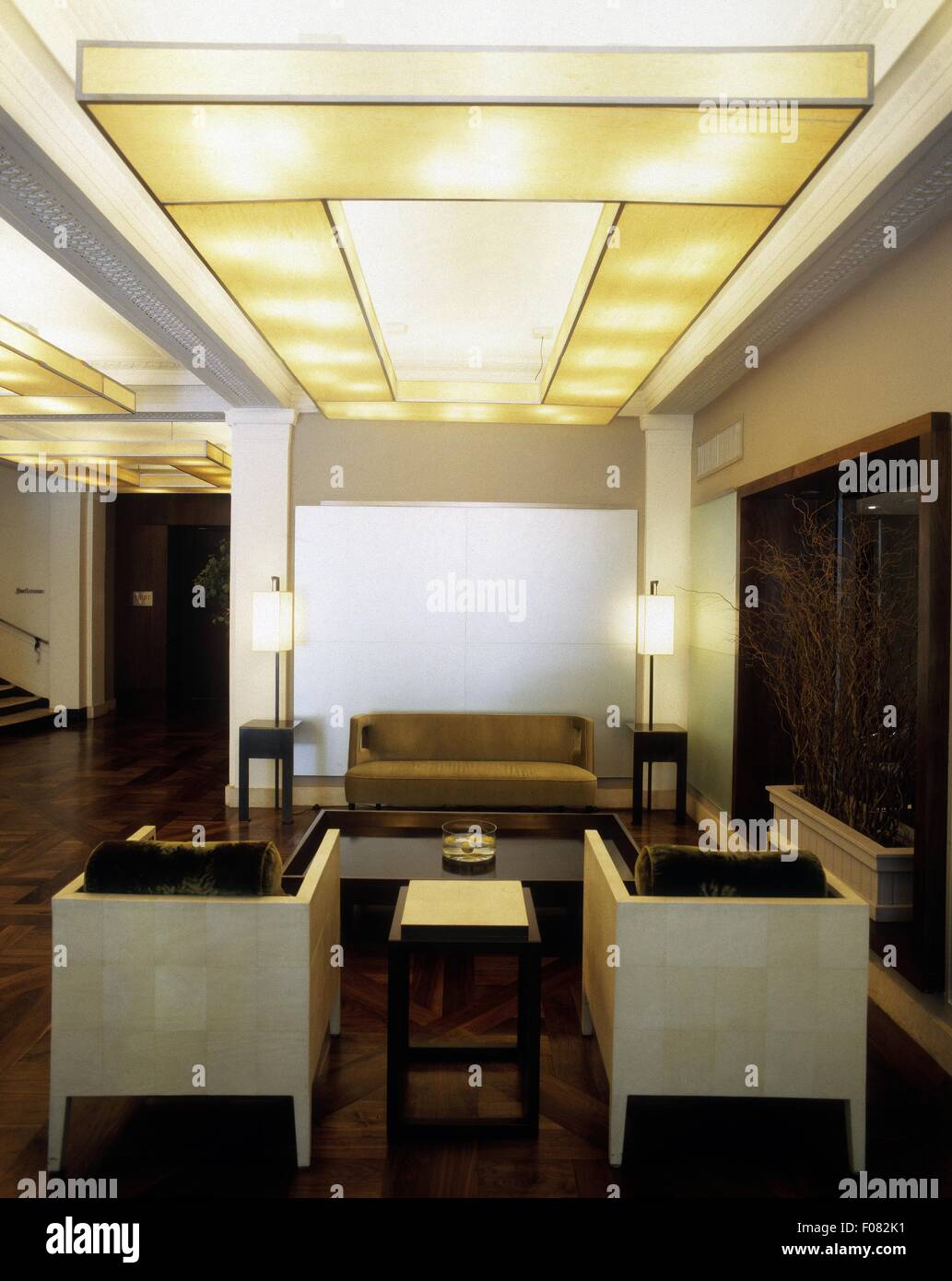 Designer lounge of Dylan Hotel in yellow light, New York, United States ...