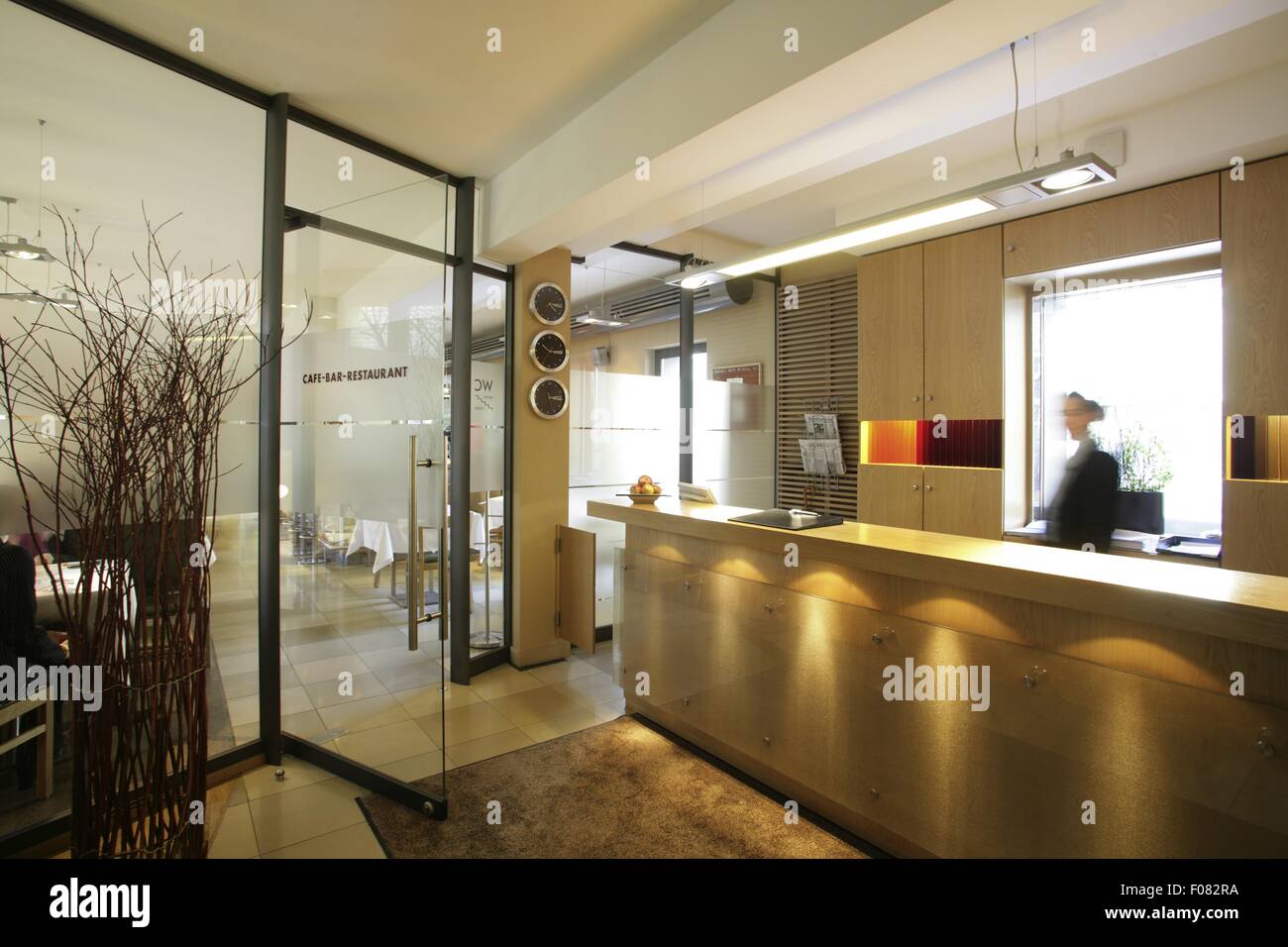 Receptionist standing at reception counter in hotel, Germany Stock ...