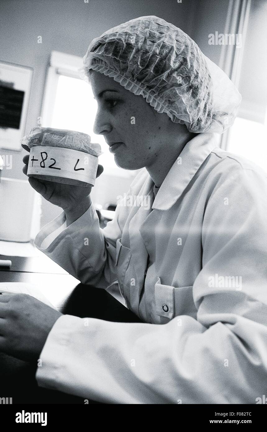 Side view of woman smelling a sample in laboratory Stock Photo - Alamy