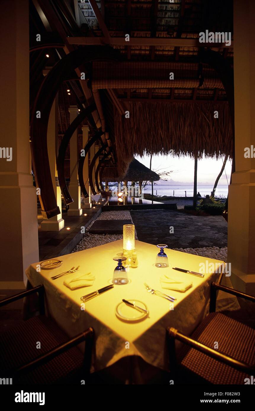 Laid table with view of sea in The Oberoi hotel, Mauritius Stock Photo ...