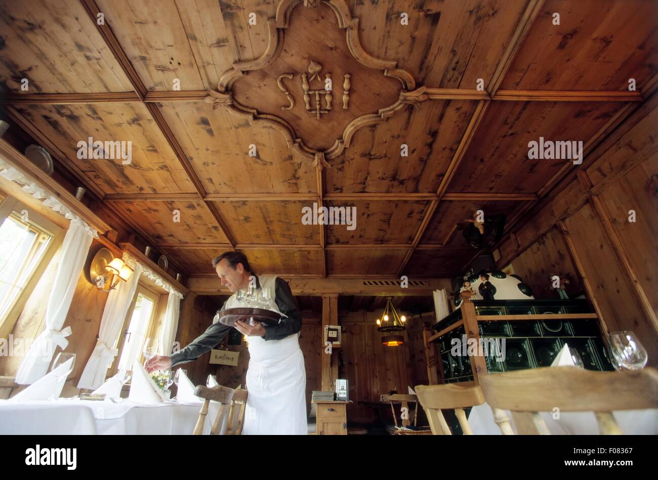 Waiter decorating a rustic table, Gasthaus-Restaurant Barnbichl, Tyrol ...