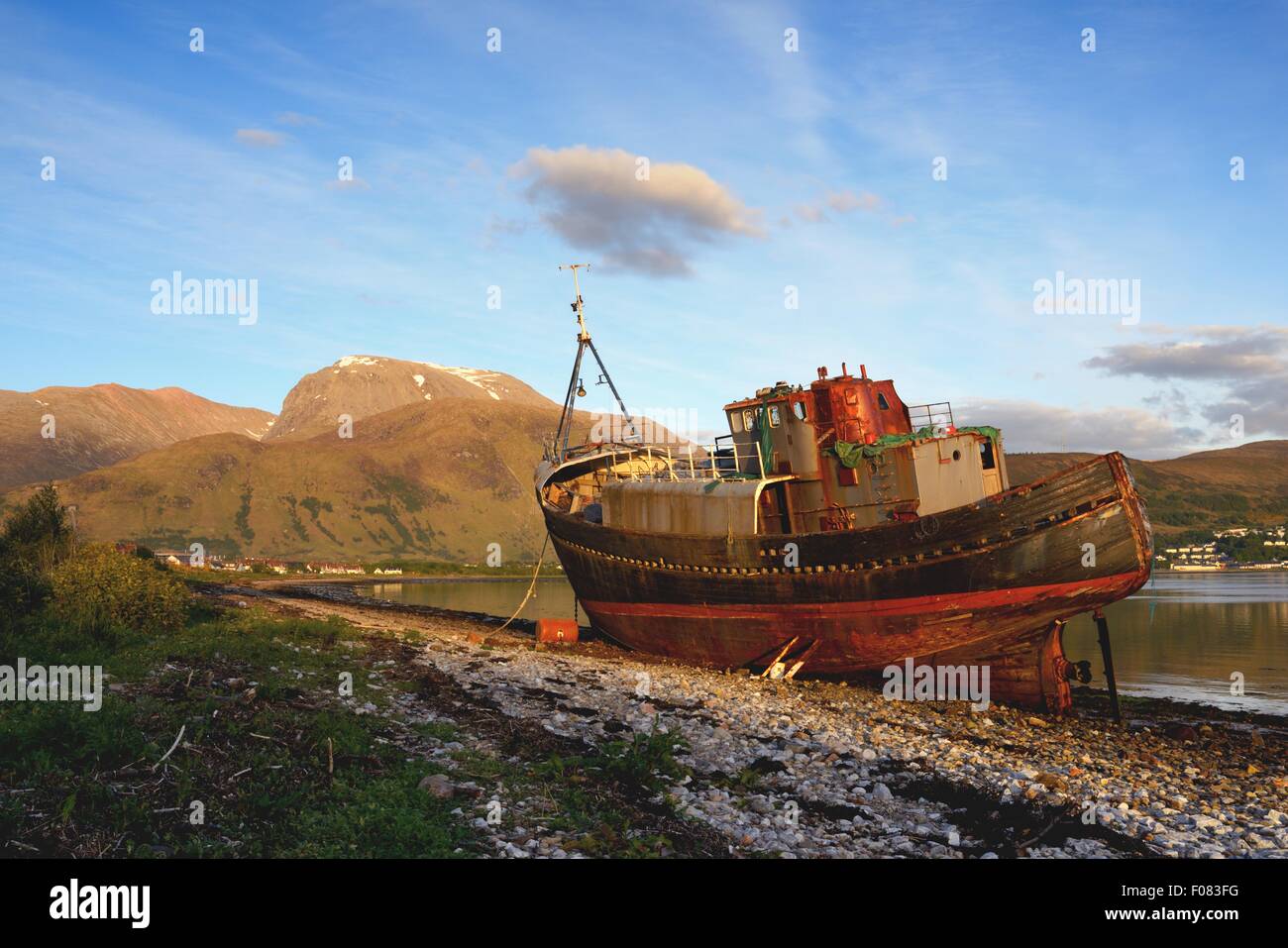 Wreck of a ship on the shores of Loch Linnhe at Corpach with Ben Nevis ...