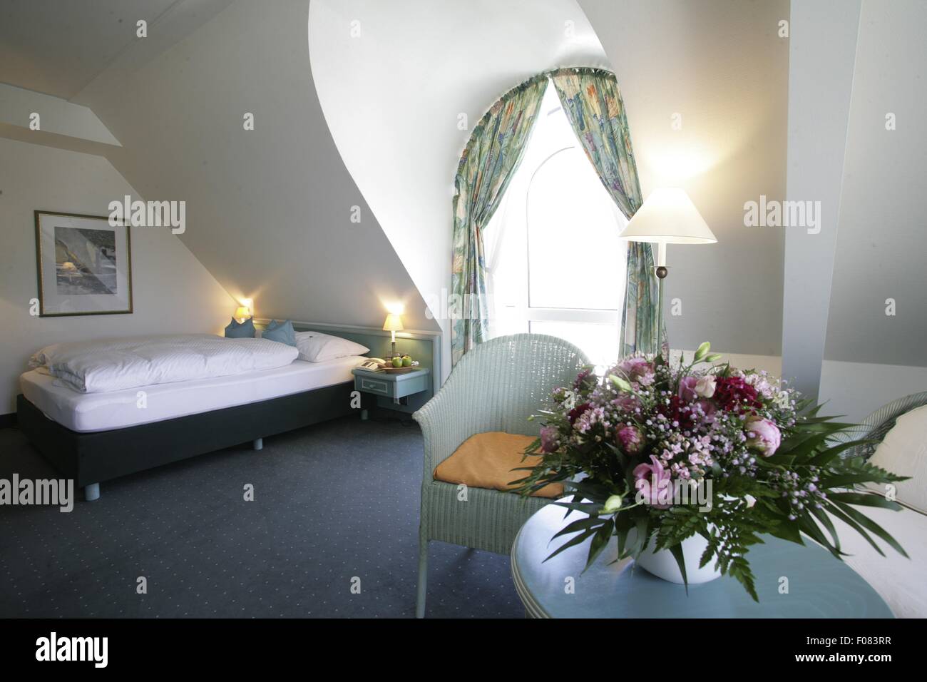 Bedroom of hotel in attic, Germany Stock Photo - Alamy