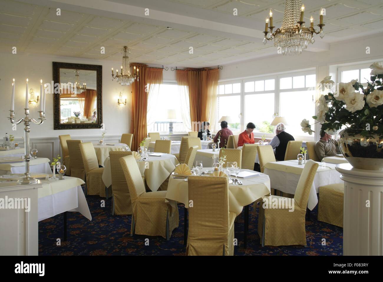Guests sitting at table in restaurant, Germany Stock Photo - Alamy