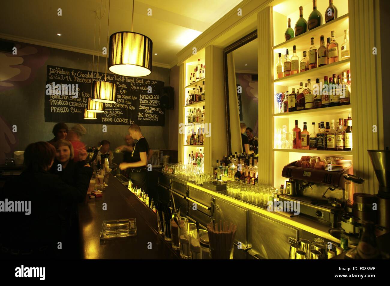 People sitting at bar counter, Germany Stock Photo - Alamy