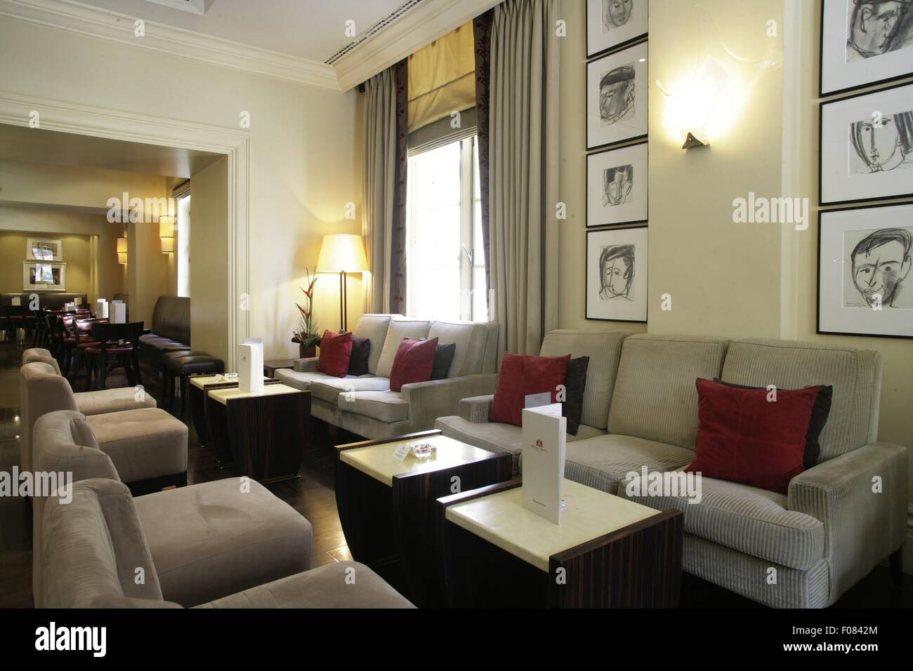 Interior of hotel with picture frames, tables and chairs, Belgium Stock ...