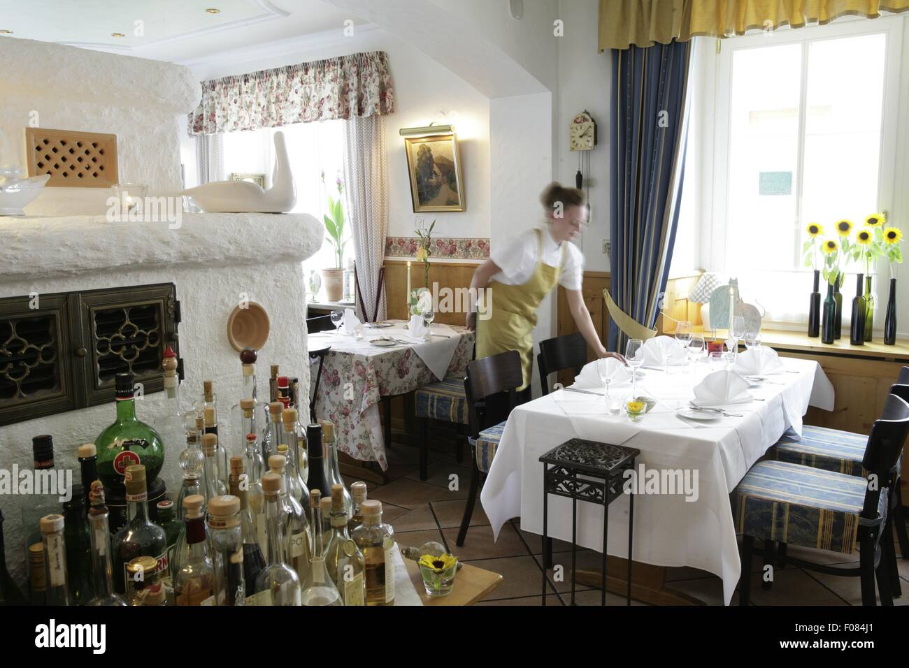 Woman setting table in restaurant, Germany Stock Photo - Alamy