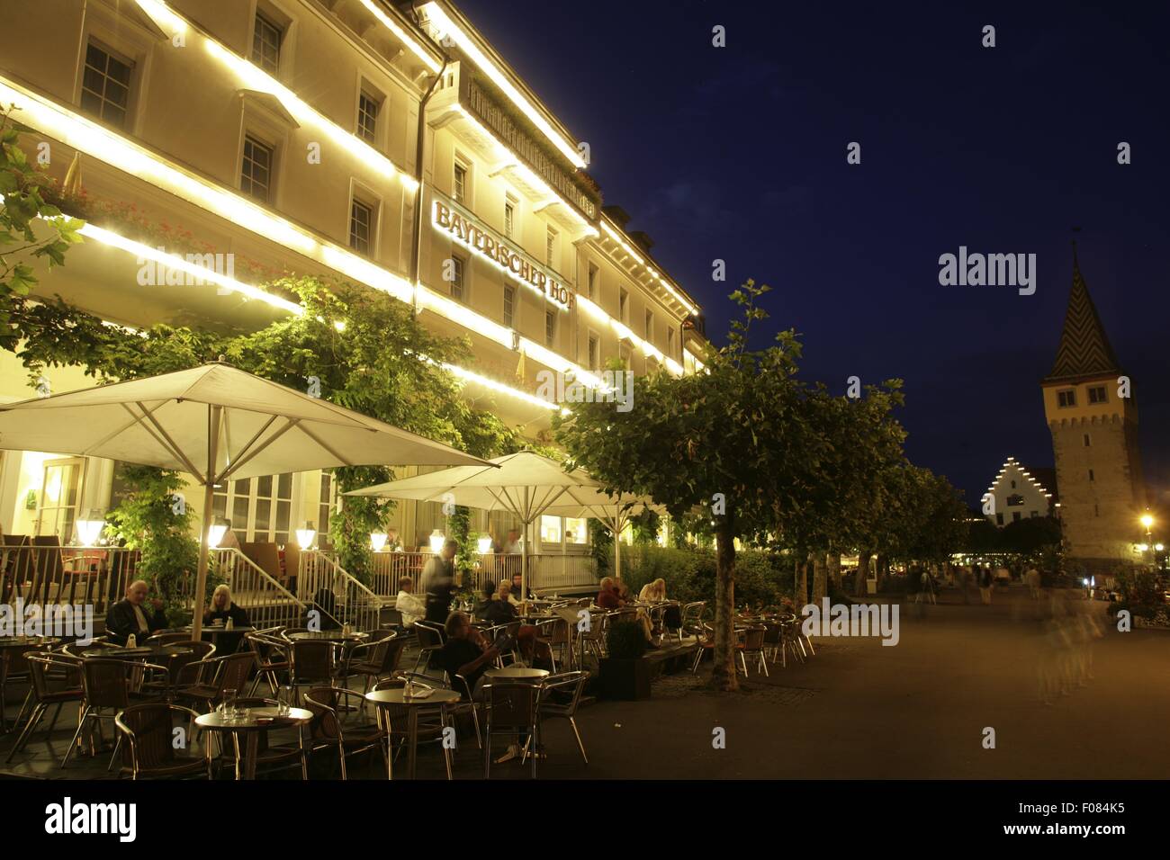 View of illuminated Bayerischer Hof hotel at night with guest, Munich ...