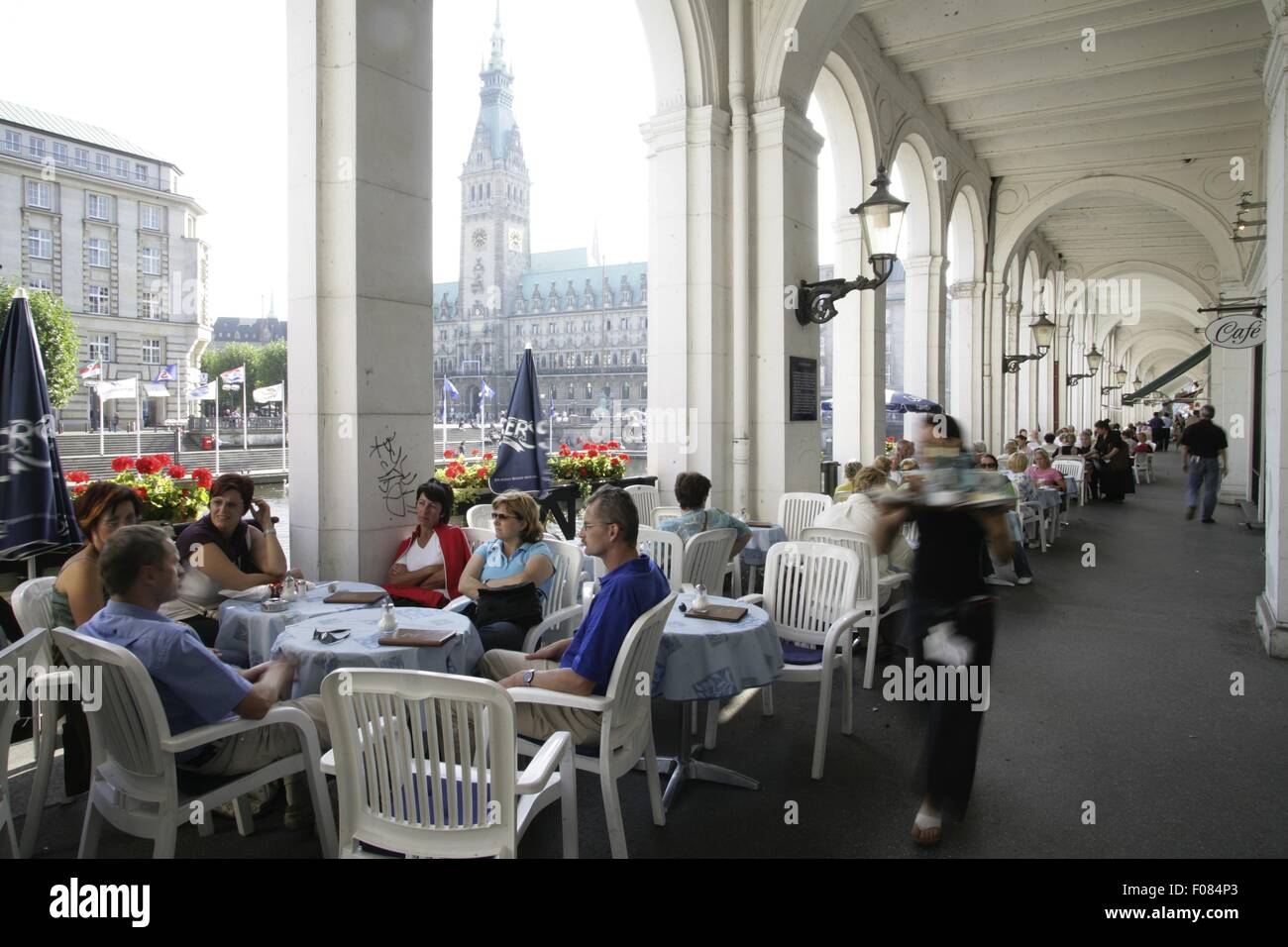 People dining in outdoor cafe at archway, Germany Stock Photo - Alamy