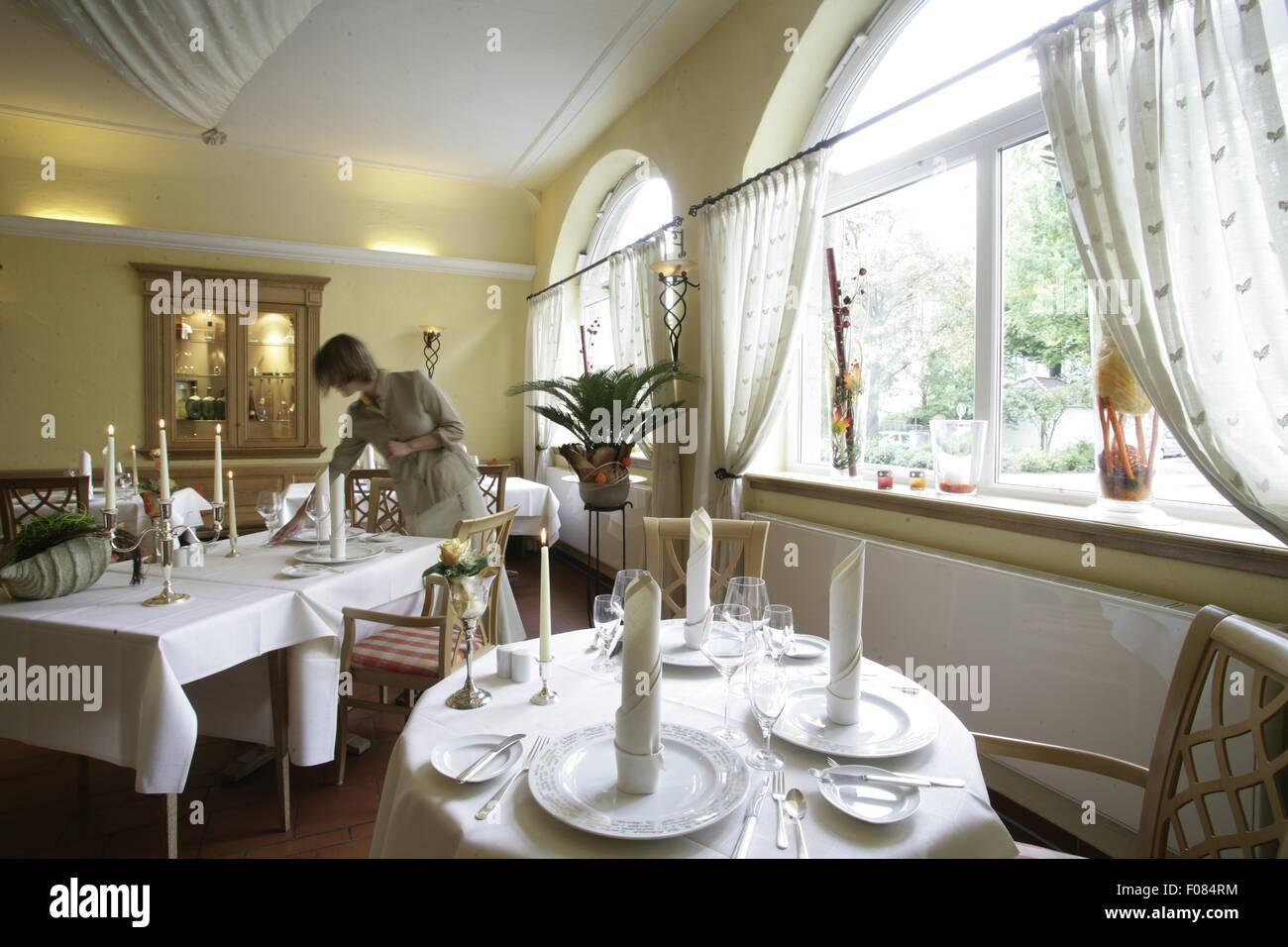Waitress setting table in restaurant, Germany Stock Photo - Alamy