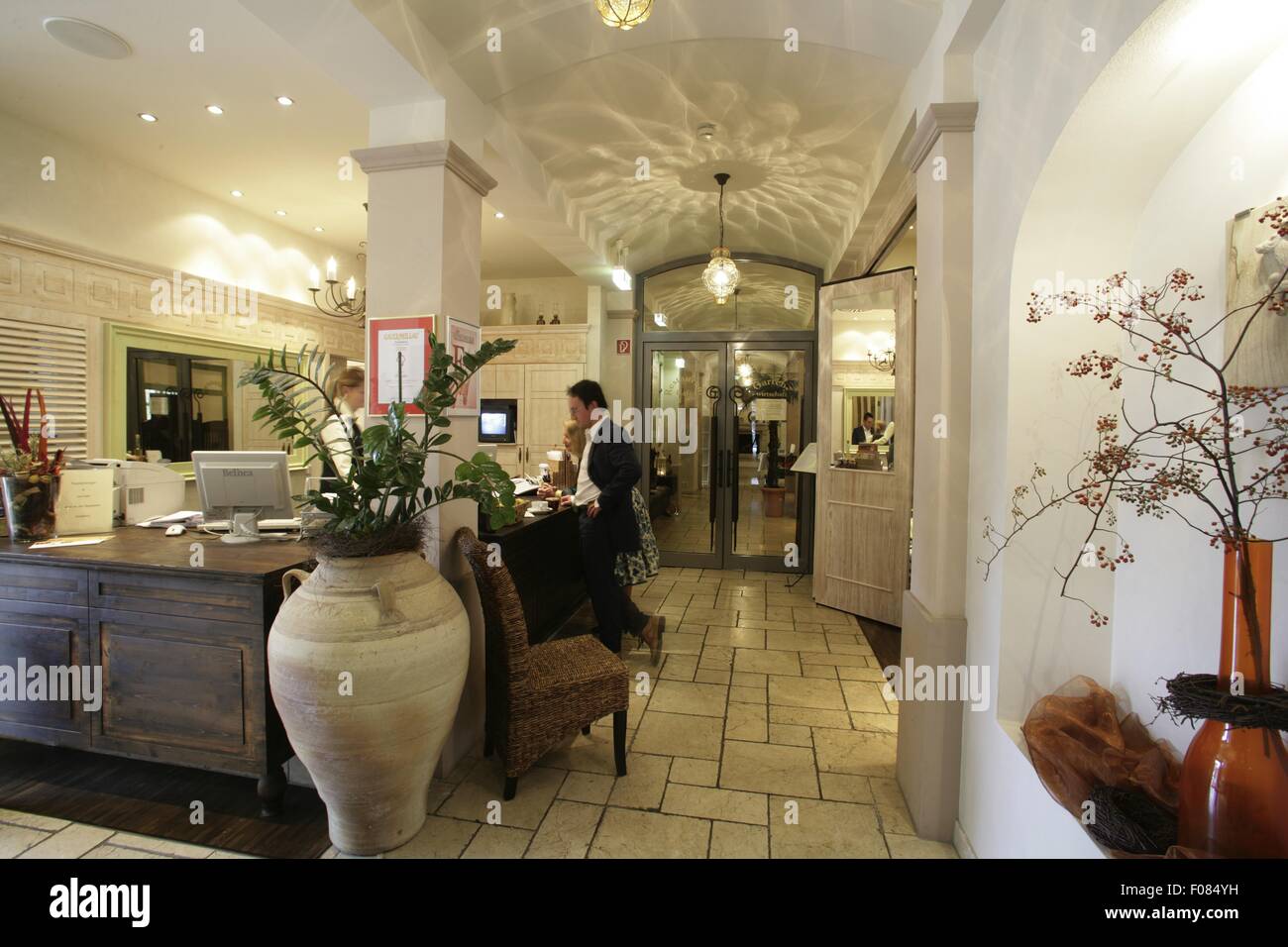 Man standing at reception counter of hotel, Germany Stock Photo - Alamy