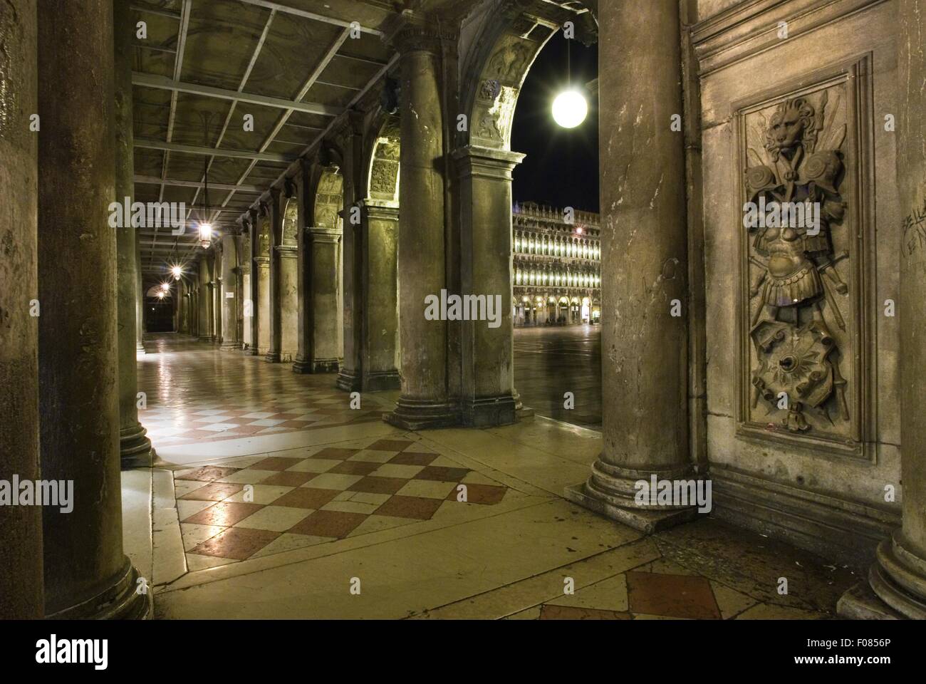 View of arches and columns of St. Mark's Square at night Stock Photo ...