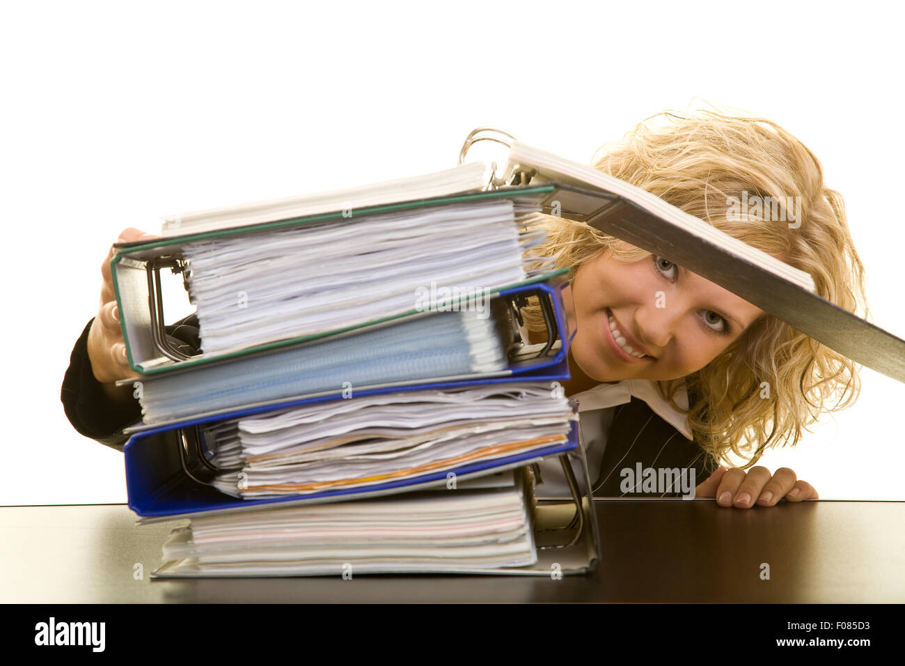 Blond business woman looking through stack of files Stock Photo - Alamy