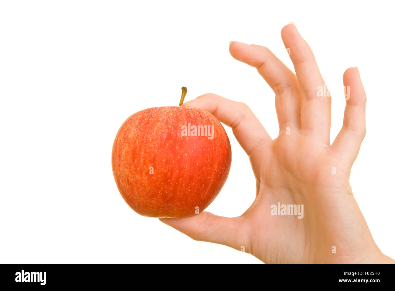 Hand showing the Okay sign with a red apple Stock Photo - Alamy