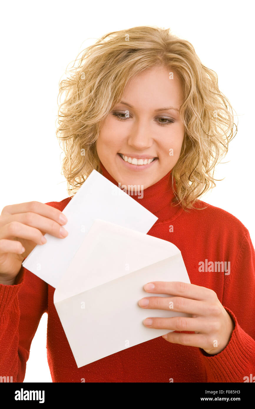 Happy young blond woman opening a letter Stock Photo - Alamy