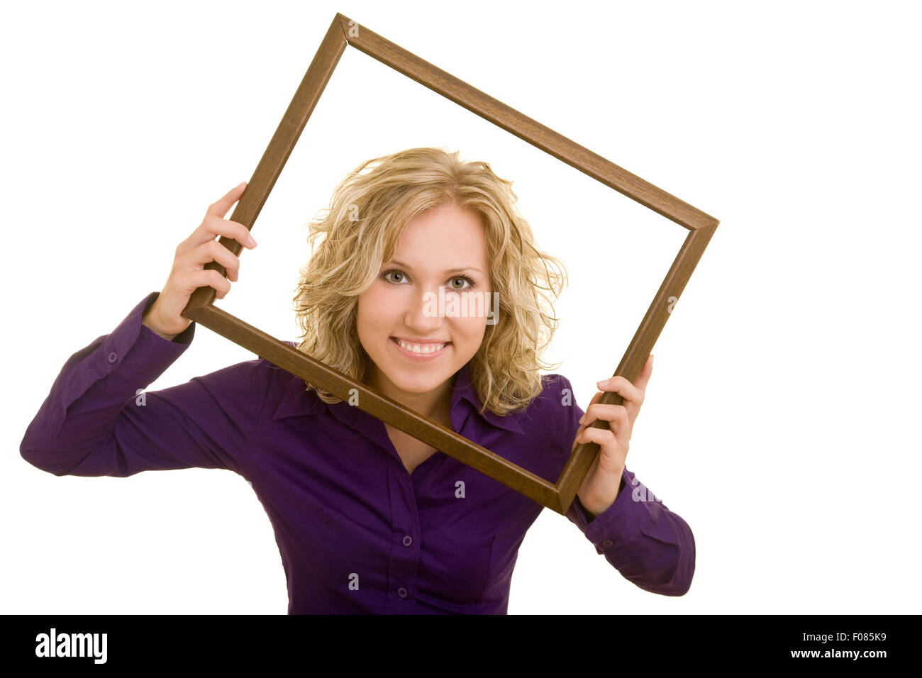 Young attractive woman looking through an empty frame Stock Photo - Alamy