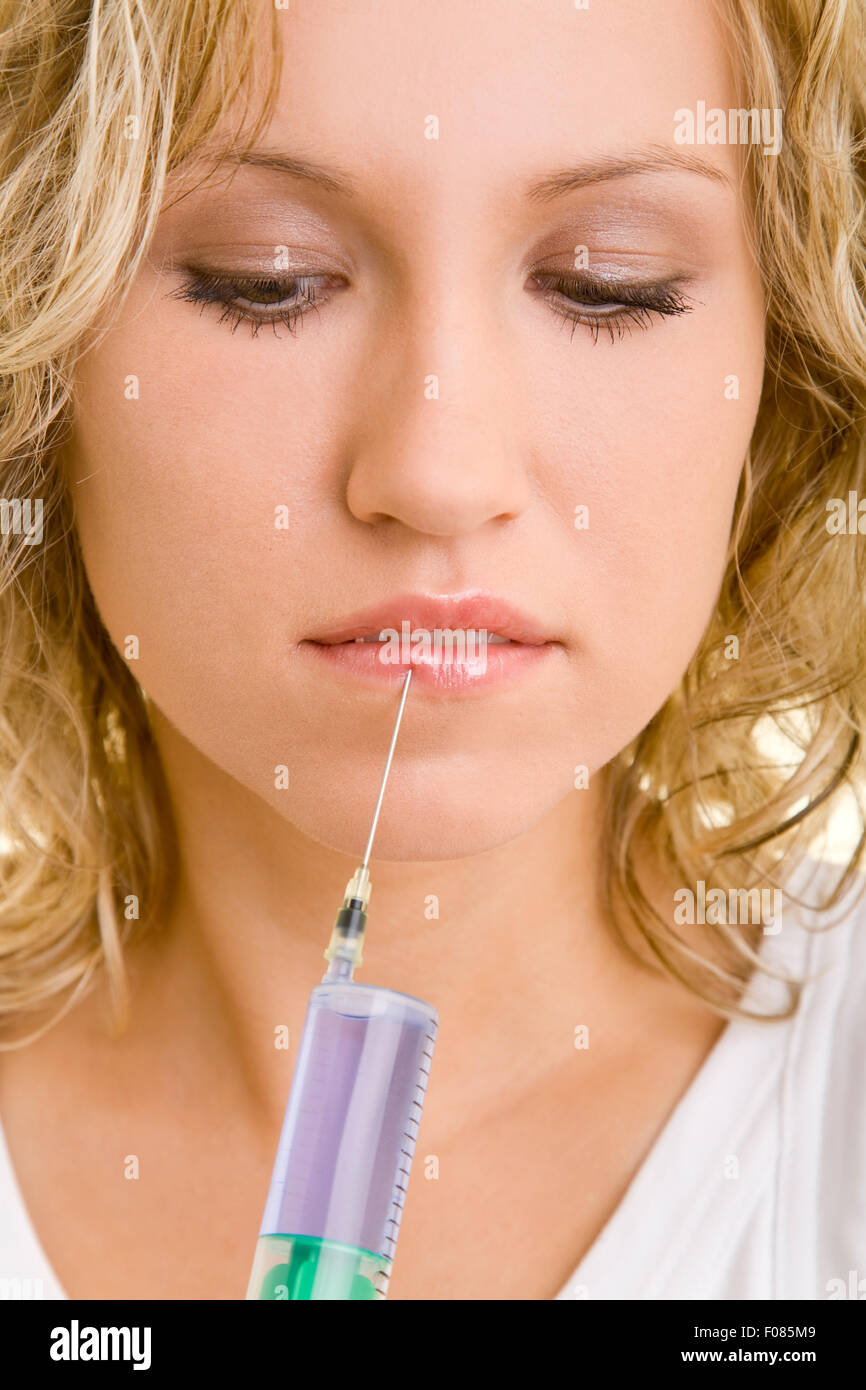 Young woman getting an injection in her lip Stock Photo - Alamy