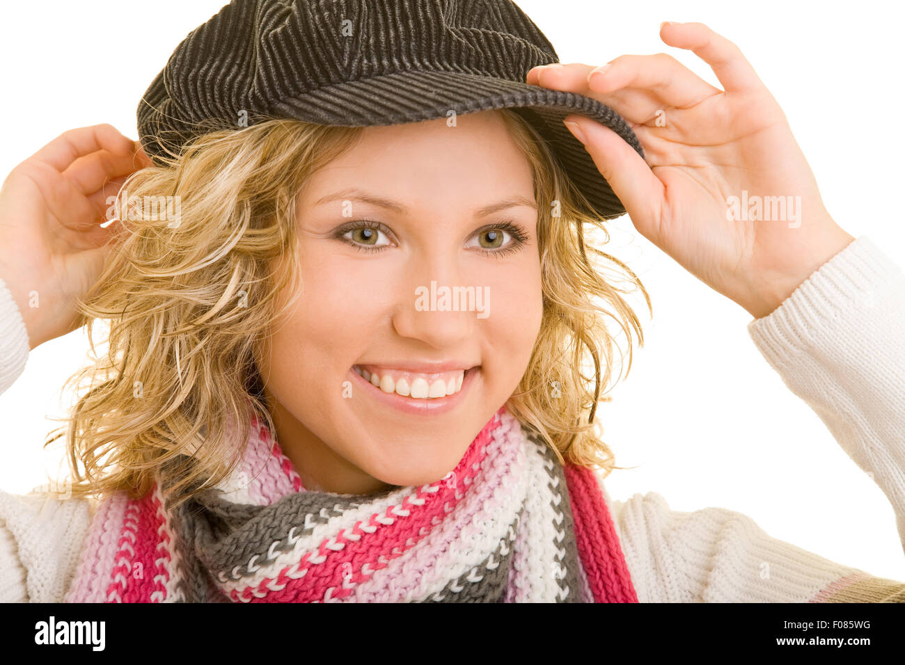 Happy smiling woman putting on cap on her head Stock Photo - Alamy