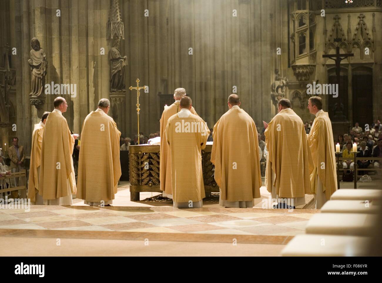 Rear view of priests worshipping in Regensburg Cathedral, Germany Stock ...