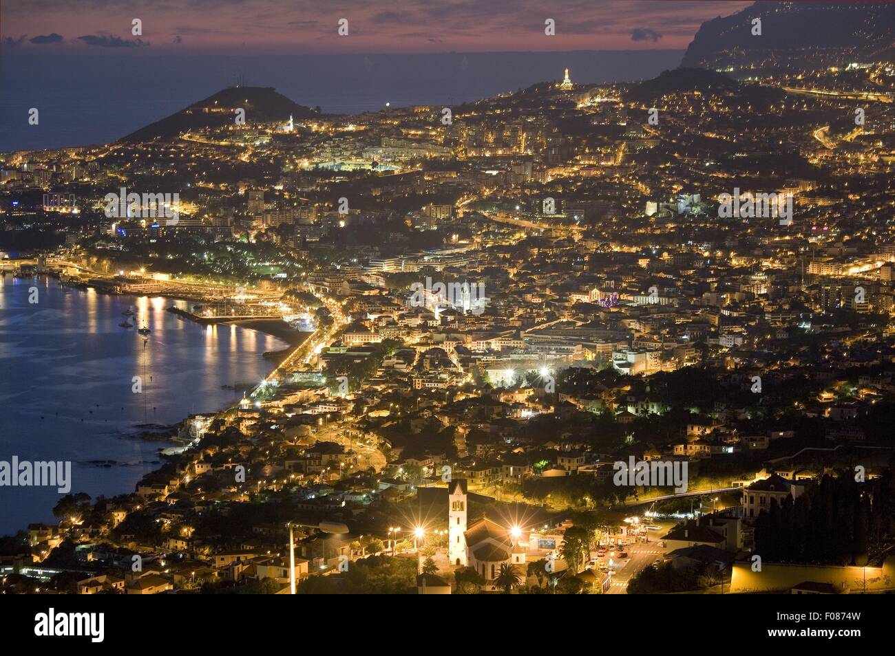 Aerial view of illuminated Funchal harbour and city at dusk, Madeira ...