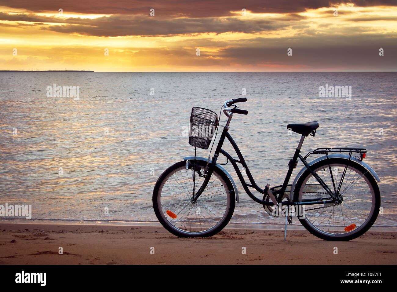 Lonely bike standing at sunset Stock Photo - Alamy