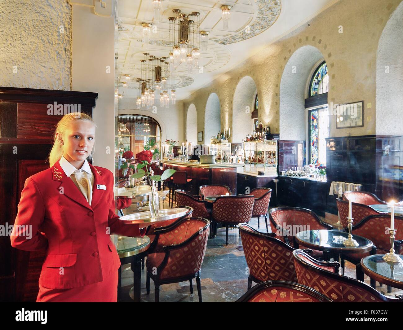 Waitress standing at lobby bar of Belmond Grand Hotel Europe in St ...