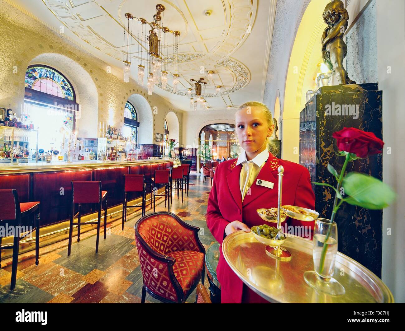 Waitress standing at lobby bar of Belmond Grand Hotel Europe in St ...