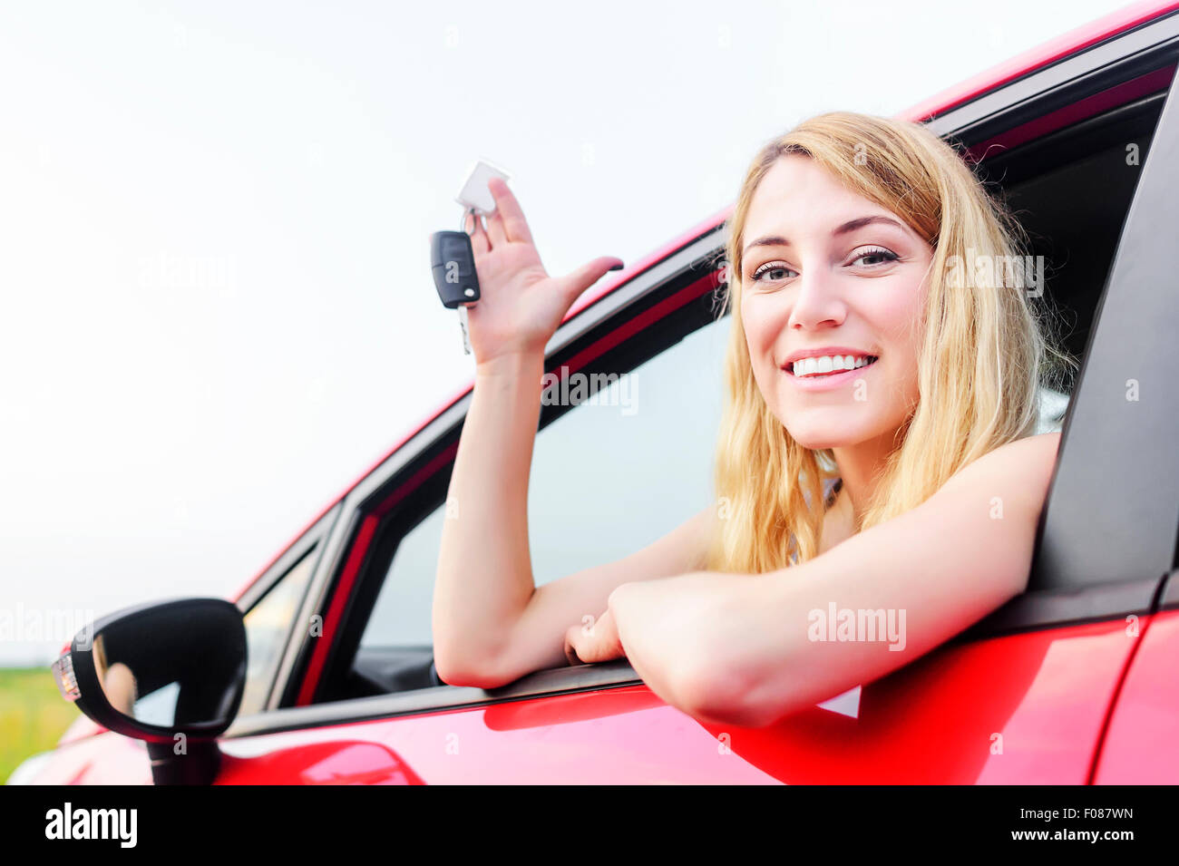 Woman showing keys Stock Photo - Alamy