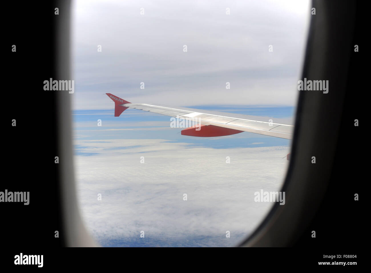 View from Easy Jet plane looking out of window at wing and land below ...