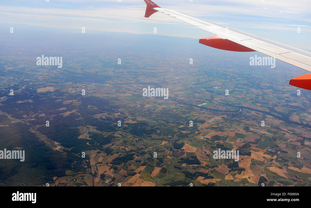 View from Easy Jet plane looking out of window at wing and land below ...