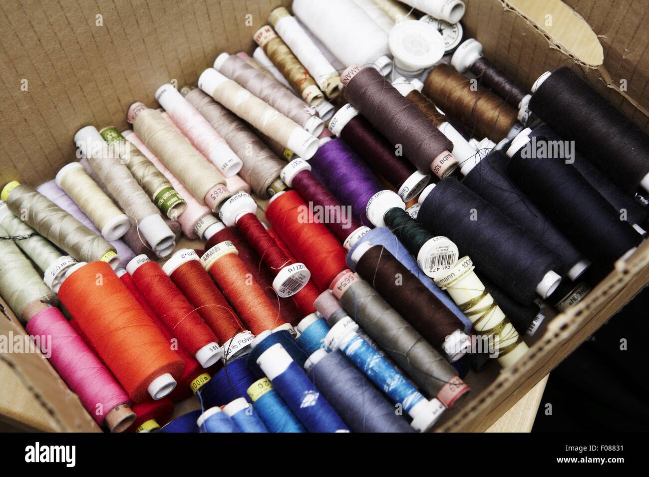 Different coloured thread in cardboard box Stock Photo - Alamy