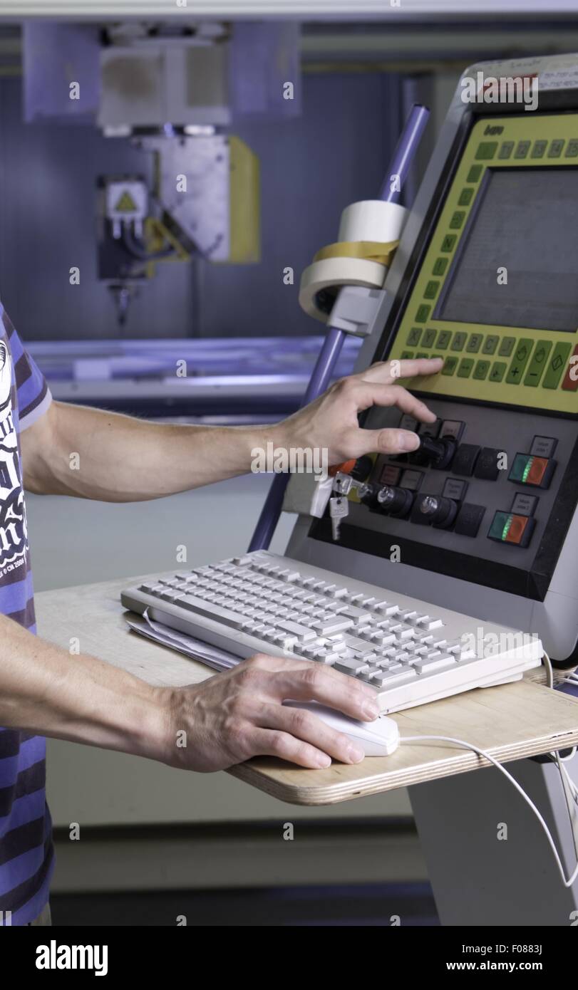 Man working on five-head CNC machine Stock Photo - Alamy
