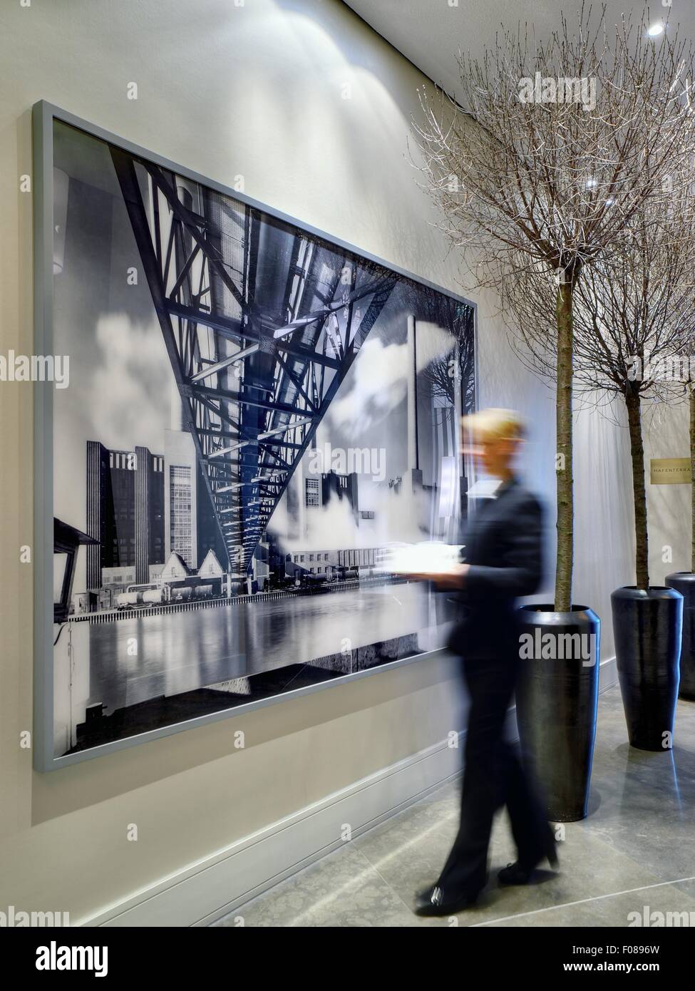 Waitress near architectural frame at the Ritz-Carlton, Wolfsburg ...