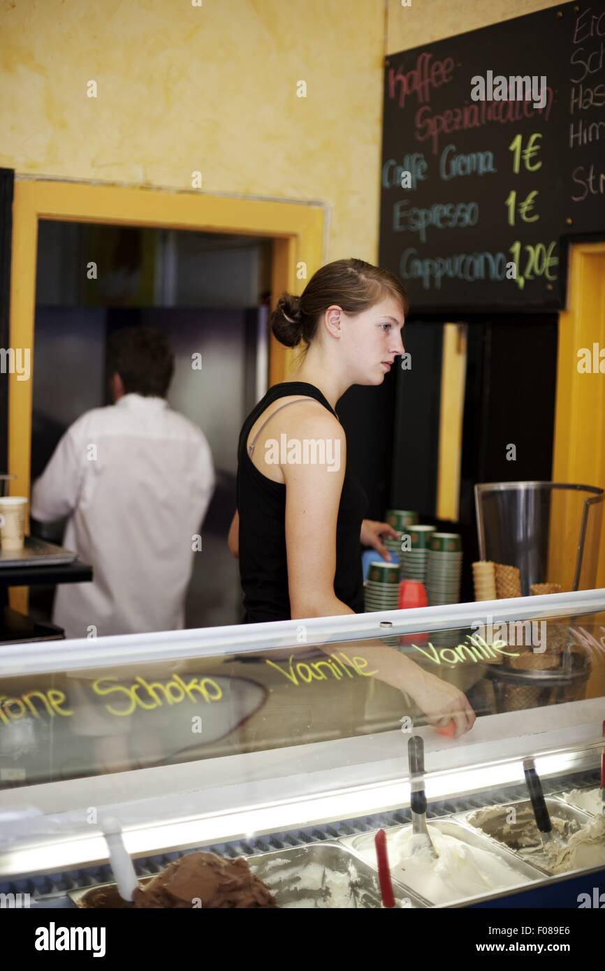 Employees at the counter of the ice cream parlour Delzepich Ice, Aachen ...