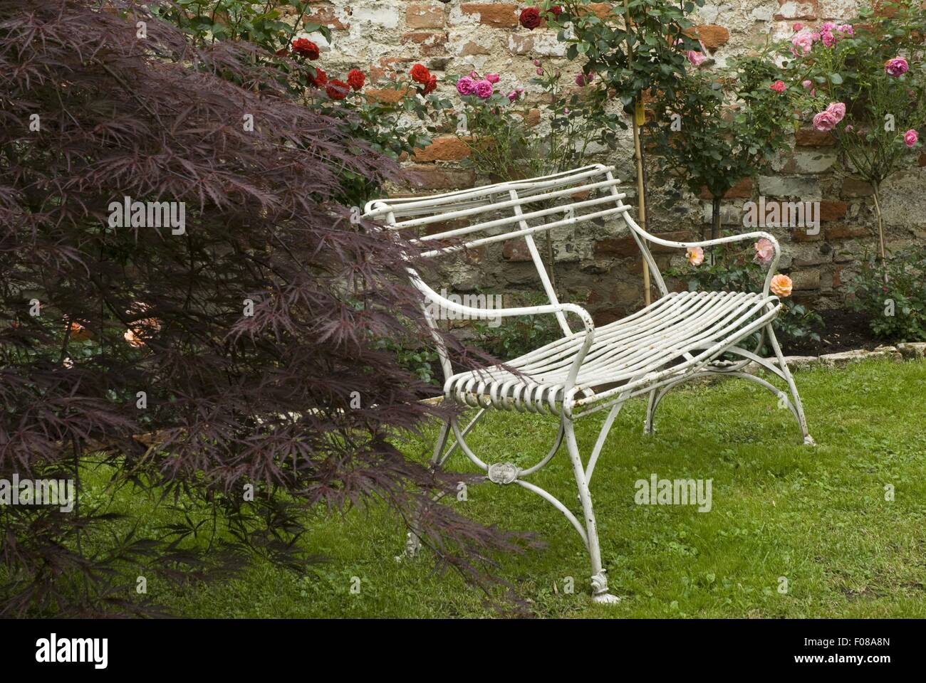 White metal bench in garden Stock Photo - Alamy
