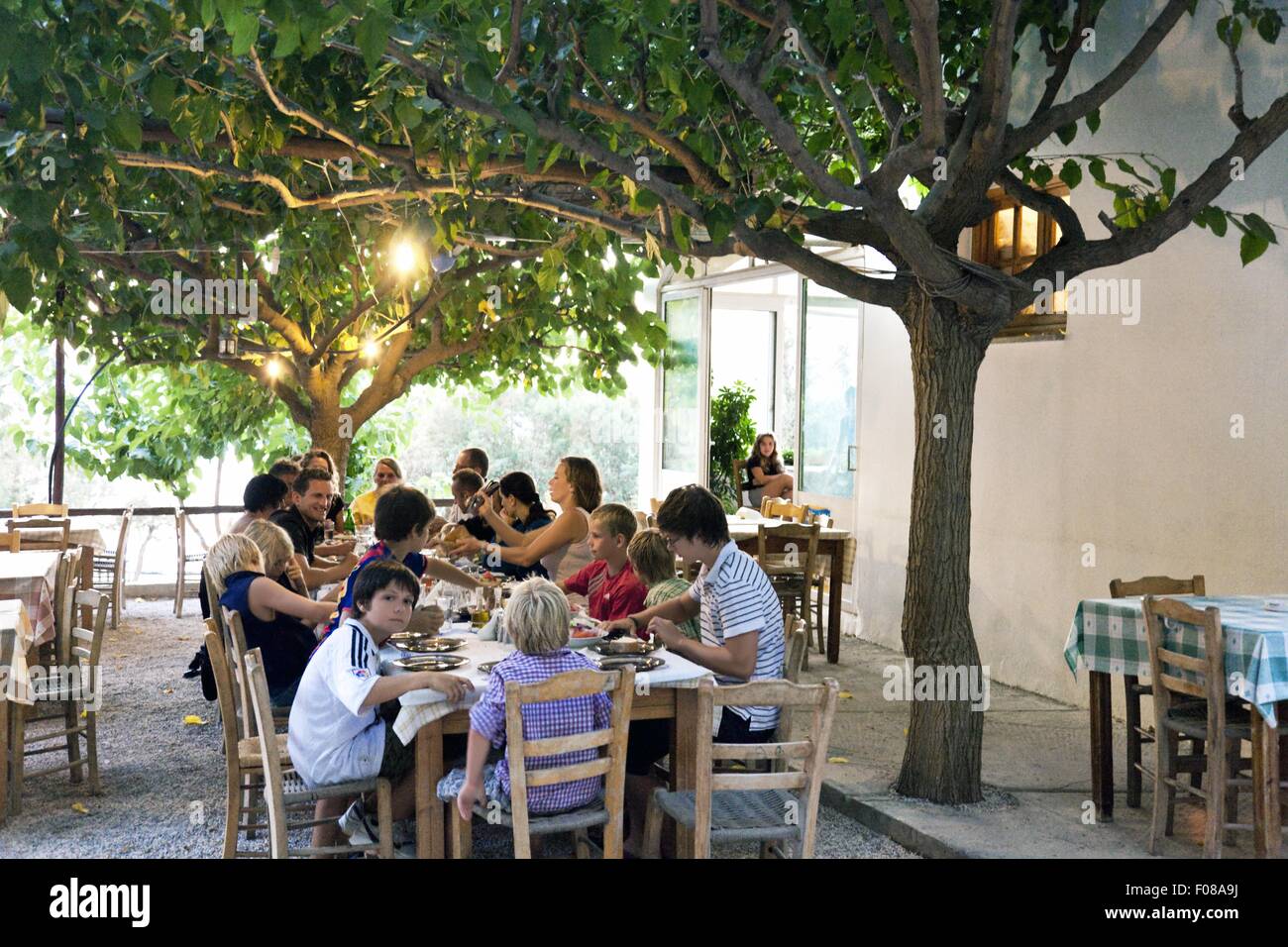 Family members at dining table having food in Crete, Greece Stock Photo ...