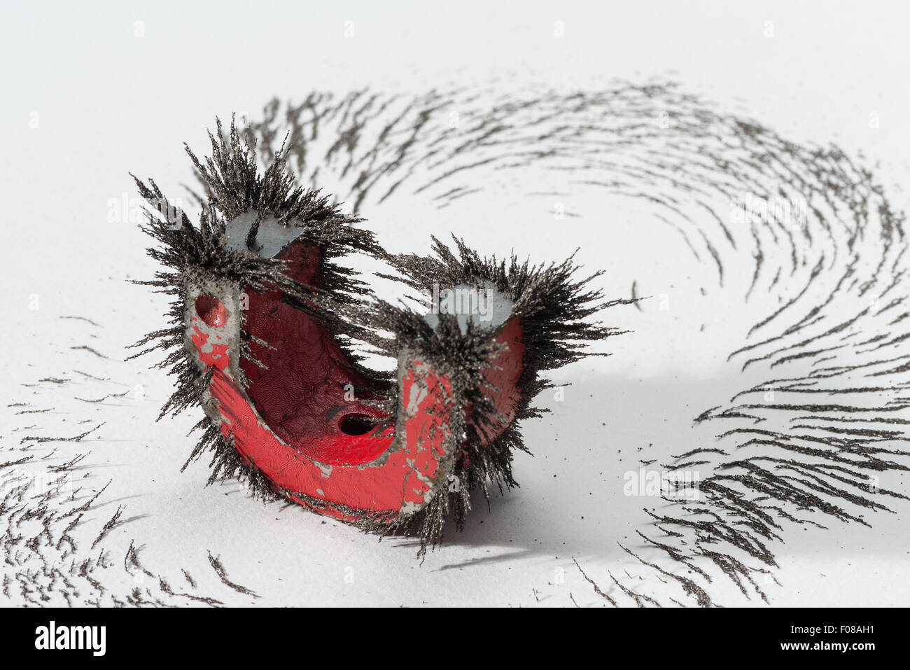 Attraction and repulsion iron metal particles align up along the ...