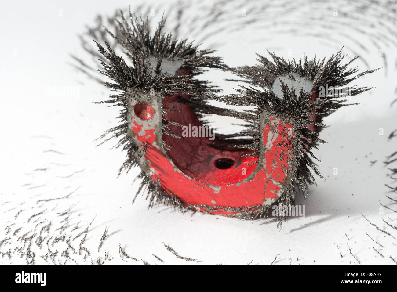 Attraction and repulsion iron metal particles align up along the ...