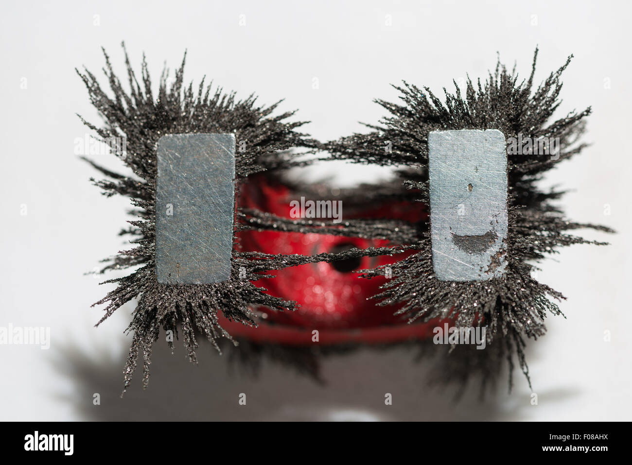 Attraction and repulsion iron metal particles align up along the ...