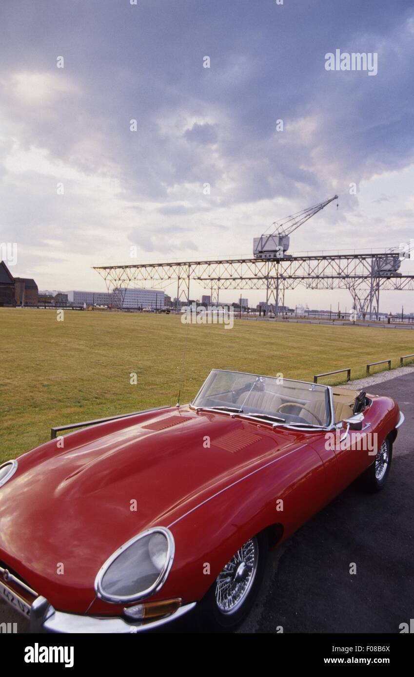 View of Red Jaguar E-type in front of port crane at Holmen, Copenhagen ...