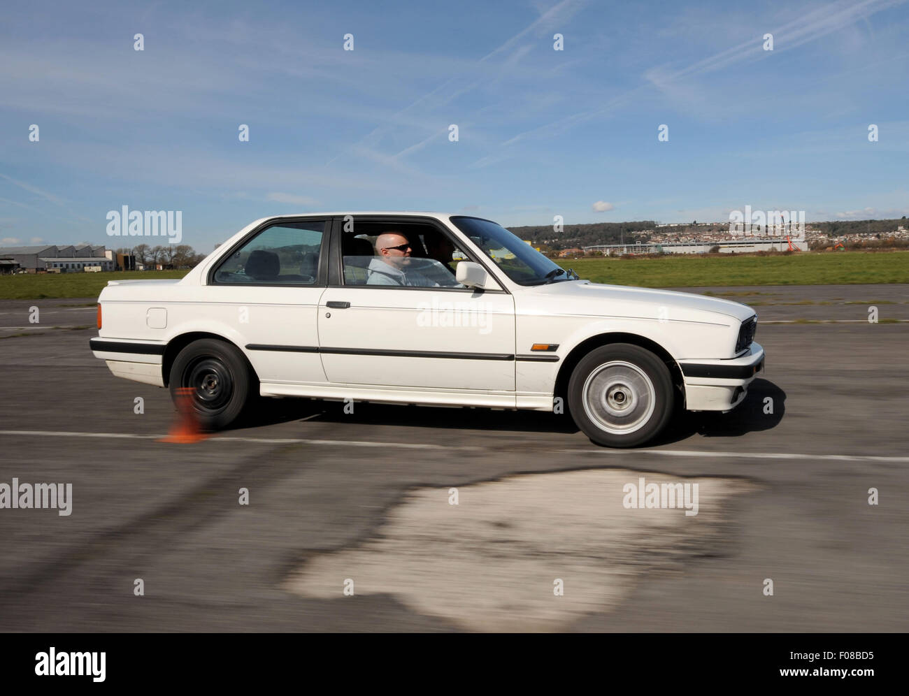 Slalom driving between cones in a BMW car Stock Photo - Alamy