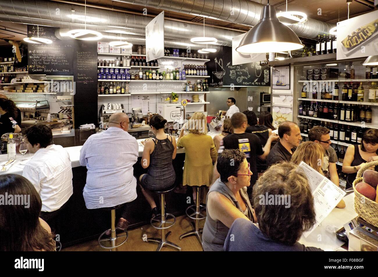 Guests sitting at sales counter in Bar Inopia, Barcelona, Spain Stock ...