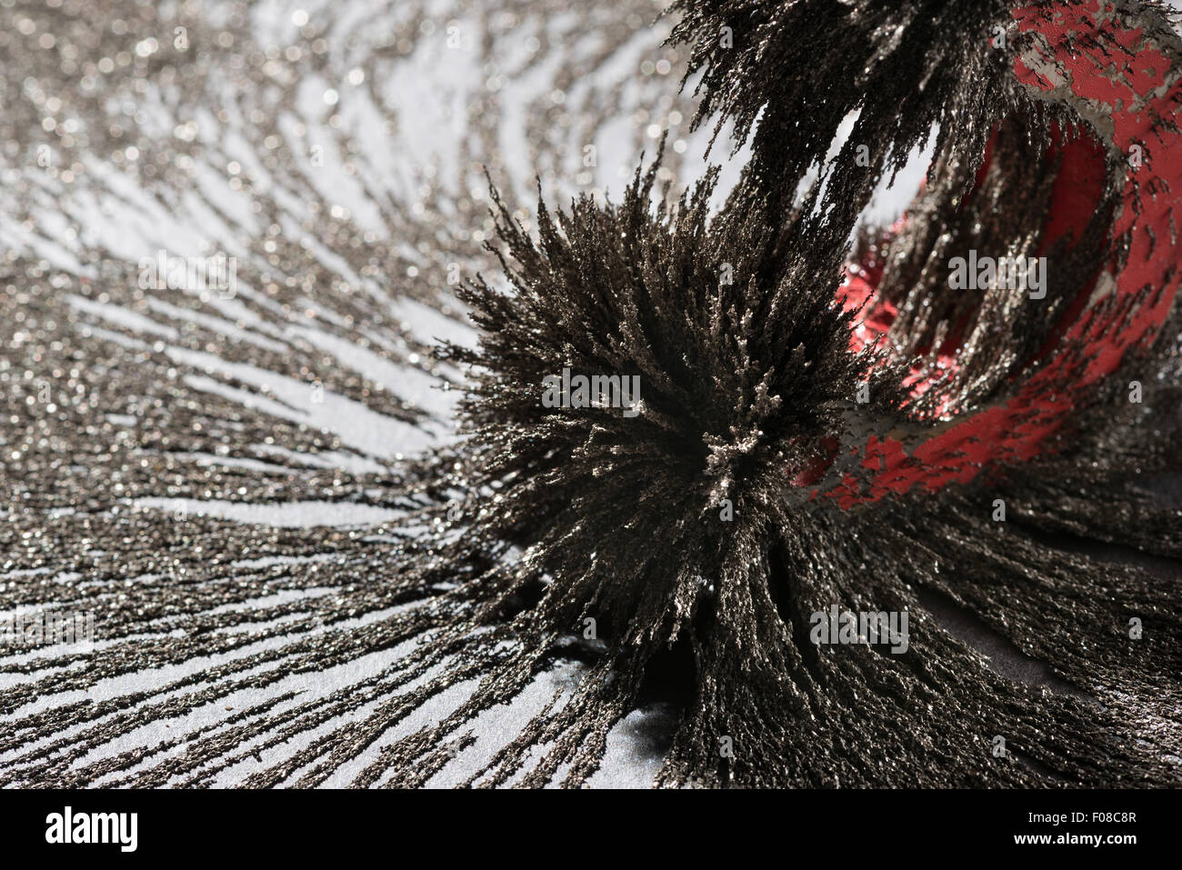 Attraction and repulsion iron metal particles align up along the ...