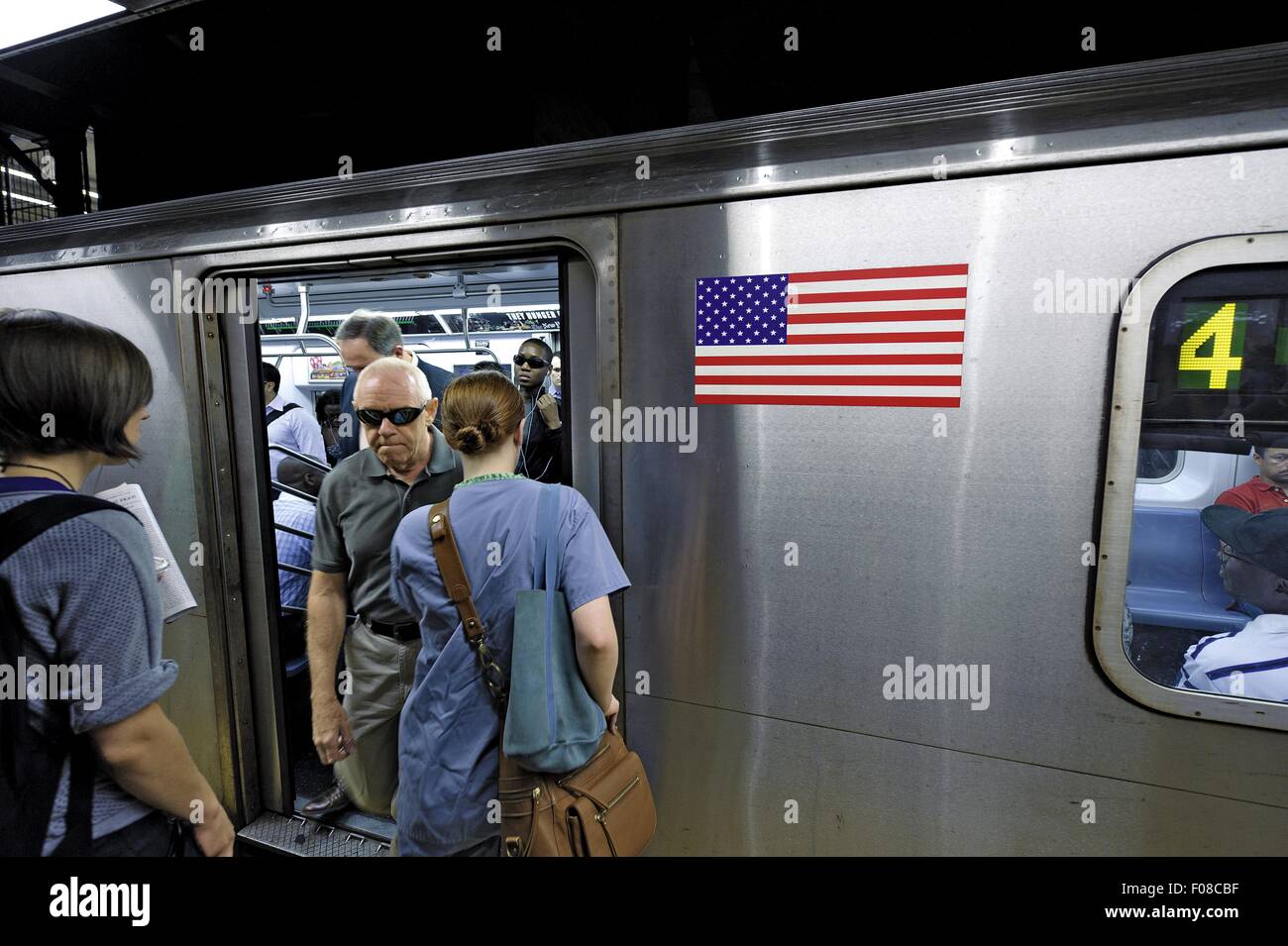 Passengers departing and boarding in train at subway, New York, USA ...
